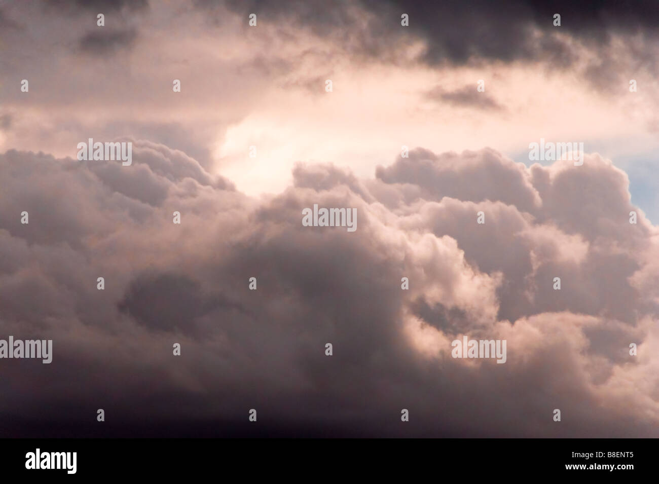 Billowing clouds with the sun breaking through illuminate the sky on an ...