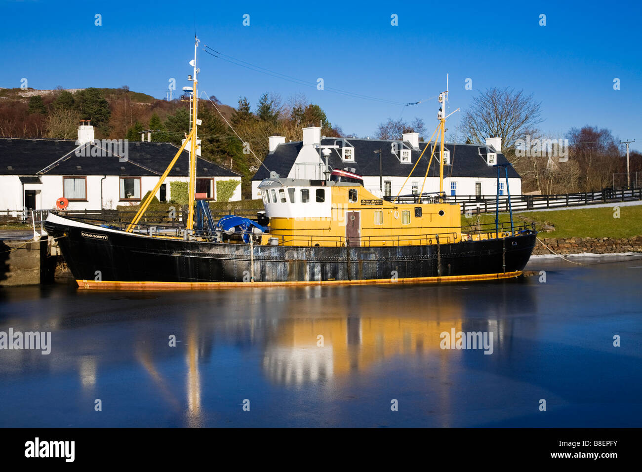 A ship moored in an iced over Caledonian Canal at Corpach near Fort ...