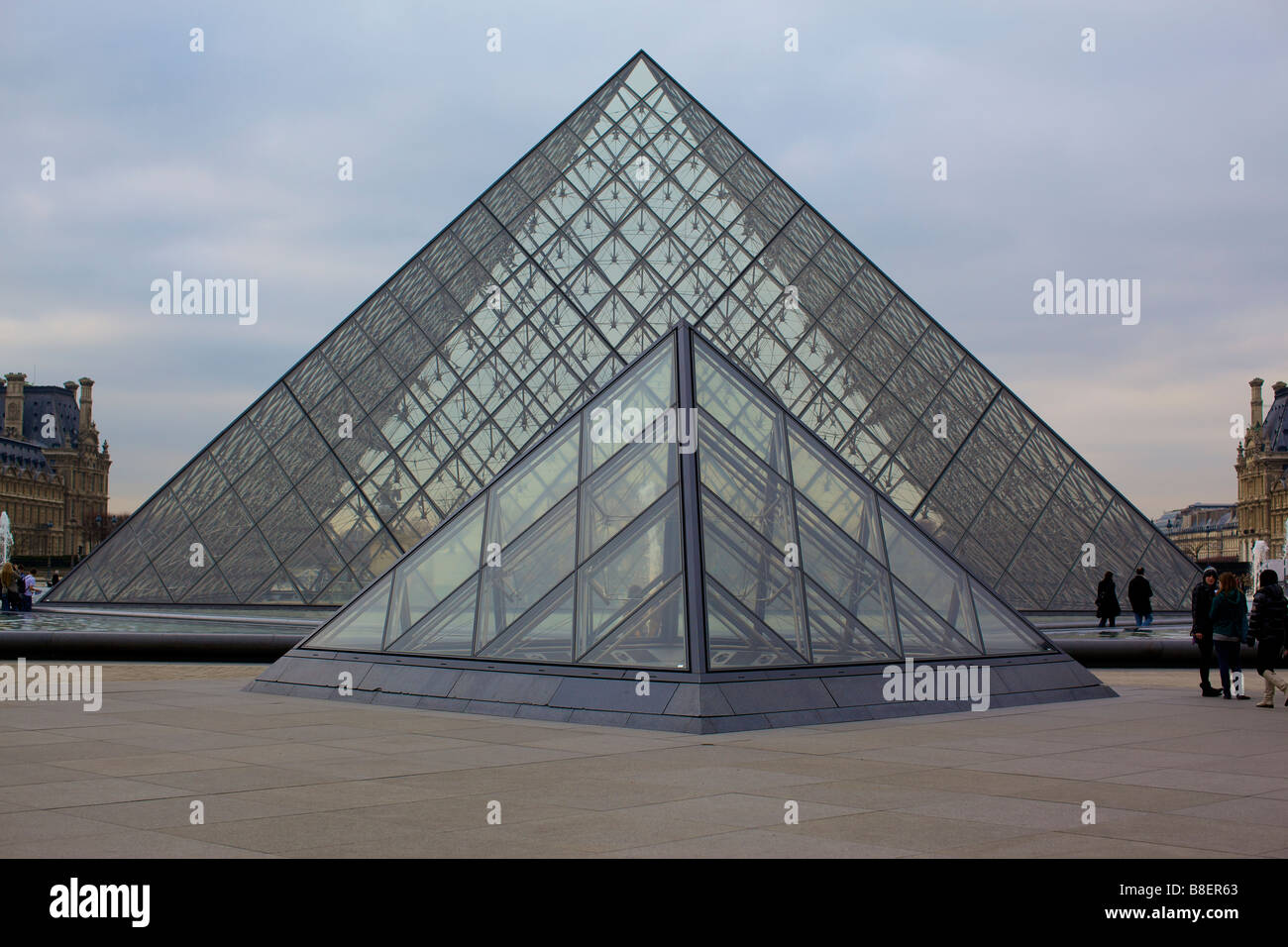 Louvre entrance pyramids Stock Photo - Alamy