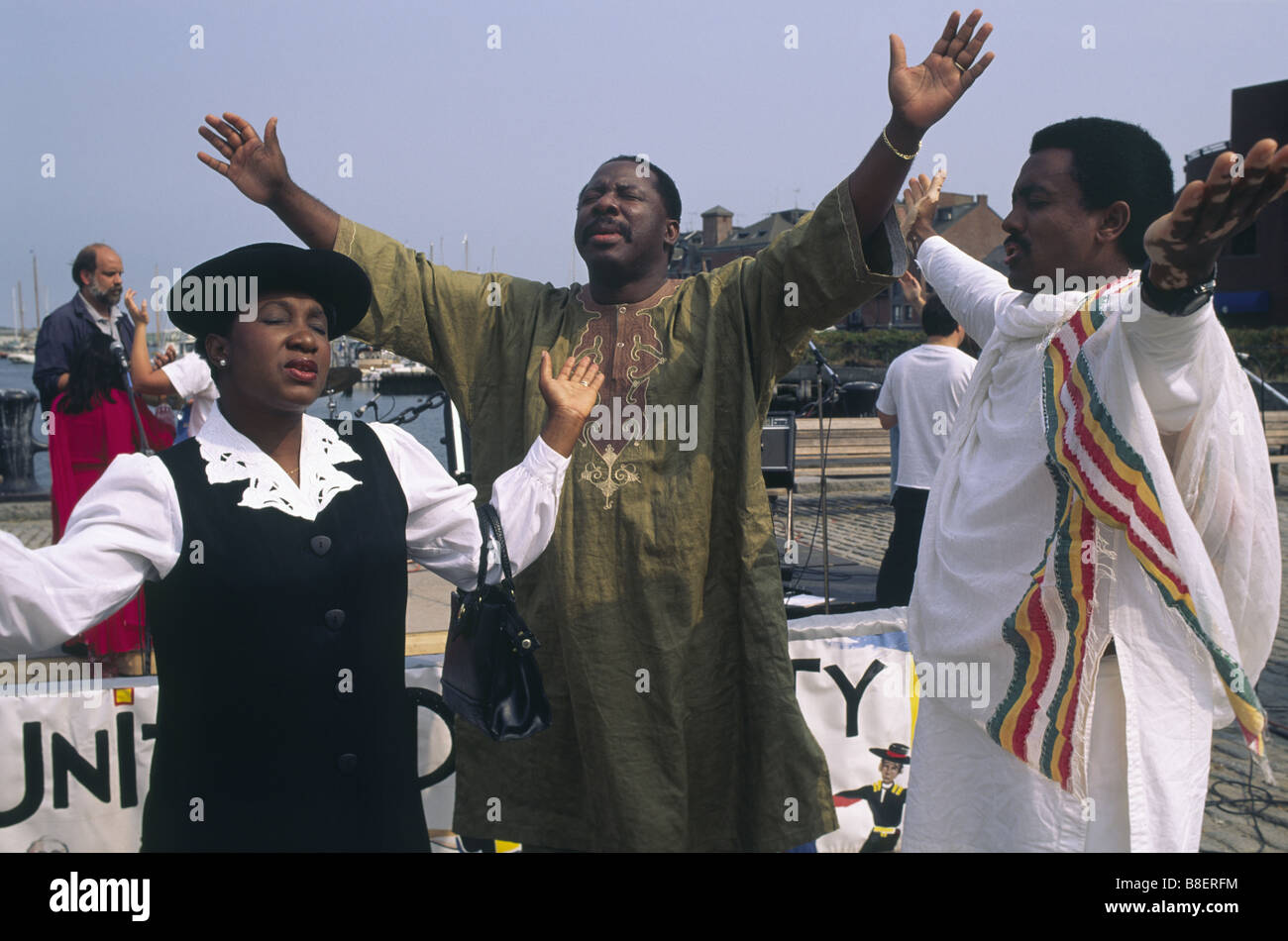 People raise their arms in prayer at an outdoor diversity prayer ...