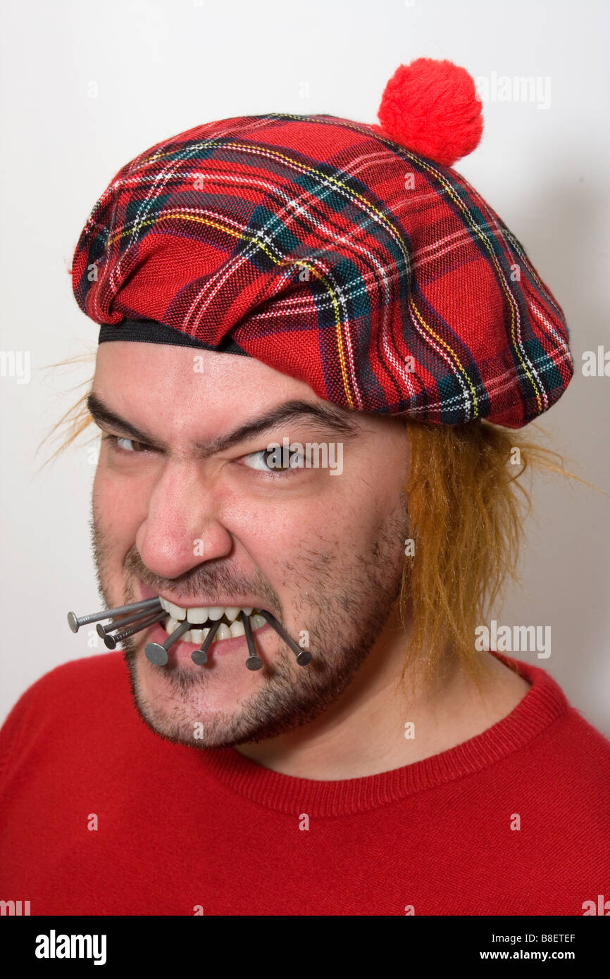 Angry Scotsman chewing nails Stock Photo - Alamy