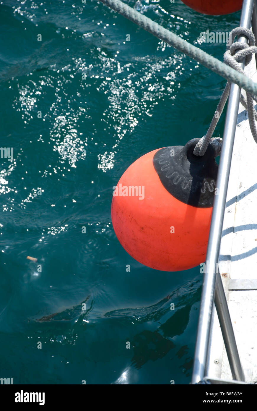 boat with orange buoys Stock Photo - Alamy