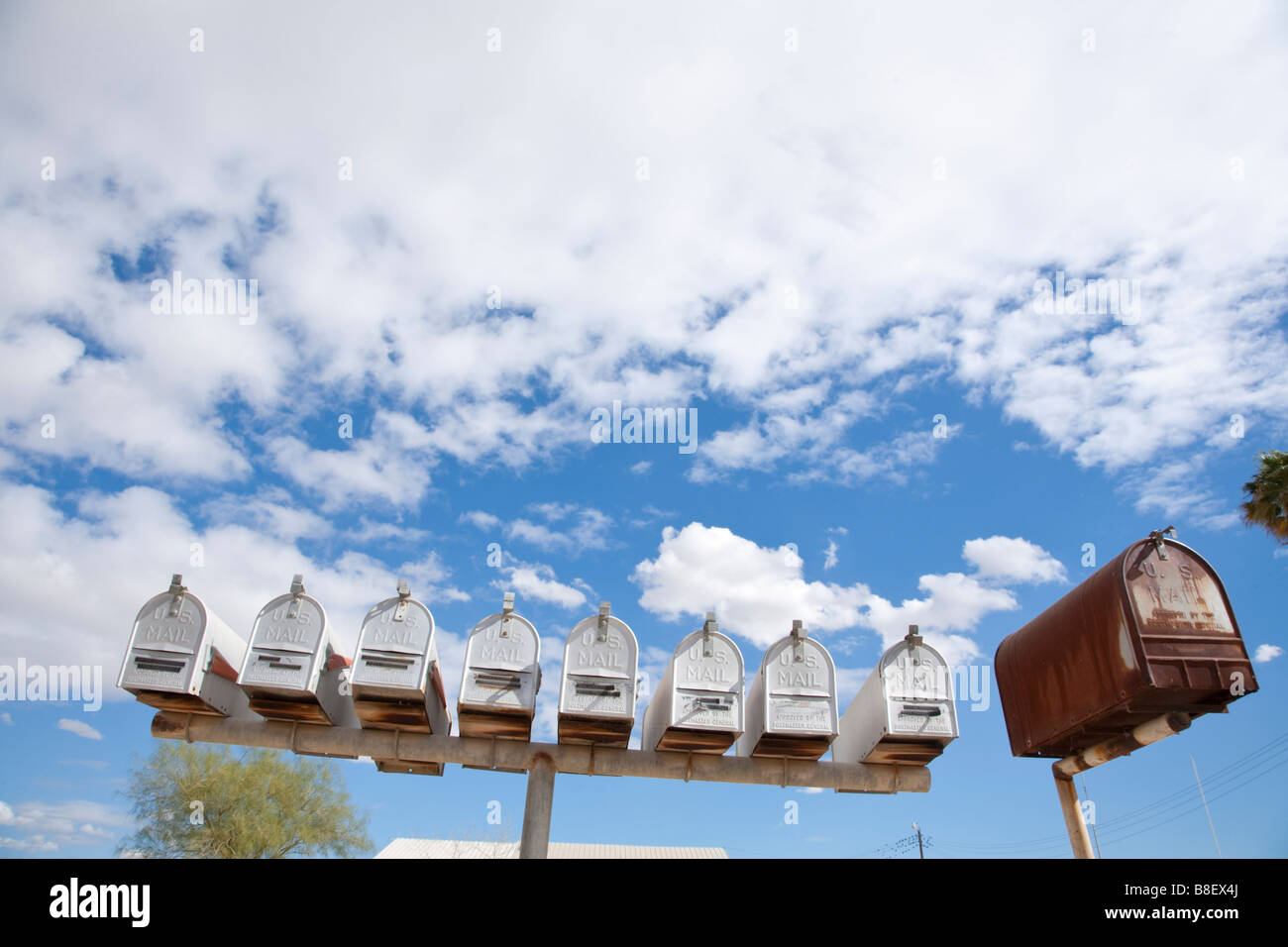 Nine mailboxes in a row against the sky in Riverside County, California ...