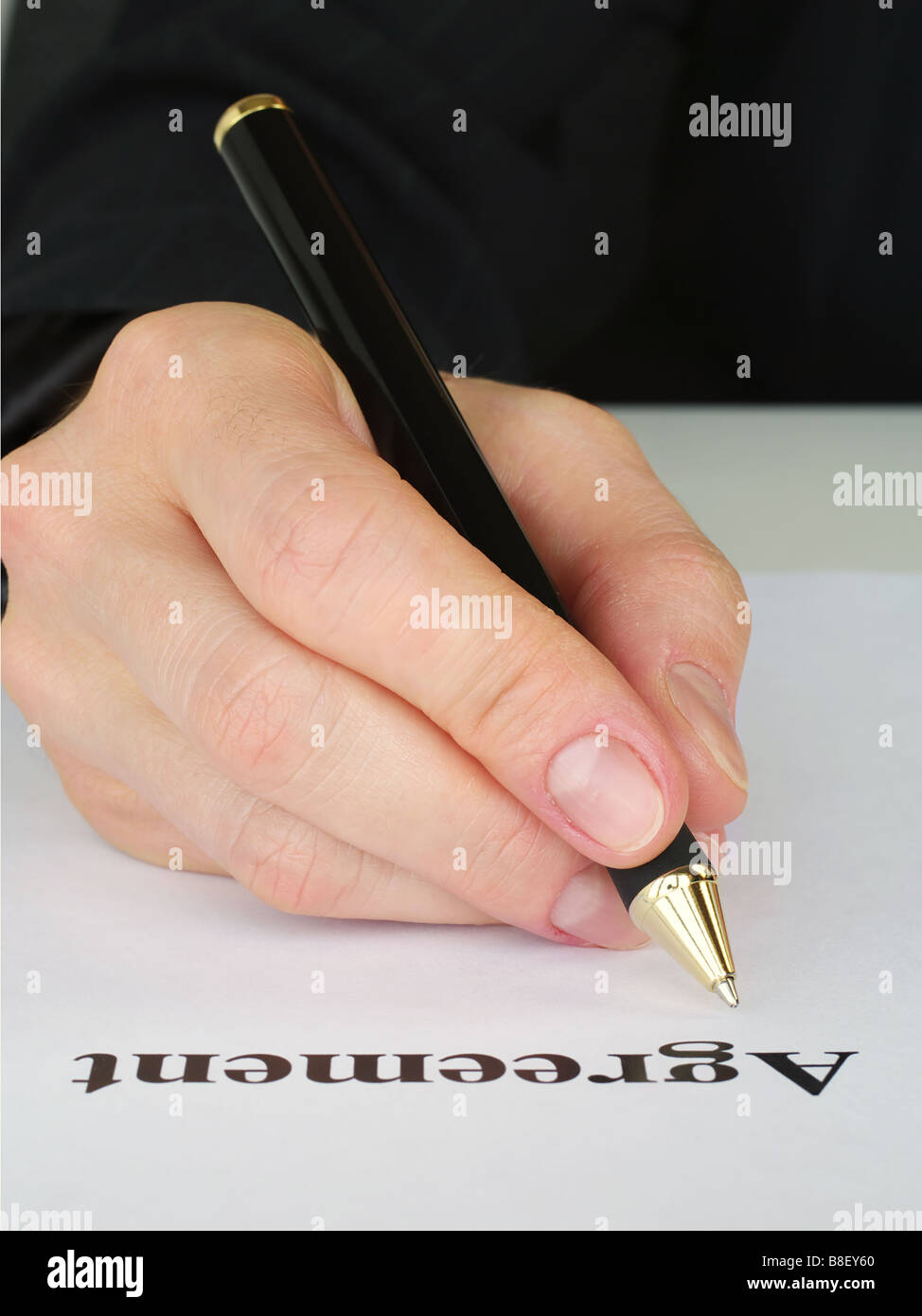 Hand signing agreement document Stock Photo - Alamy