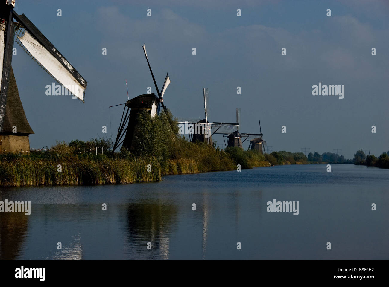 Traditional Dutch Windmills along a River Stock Photo - Alamy