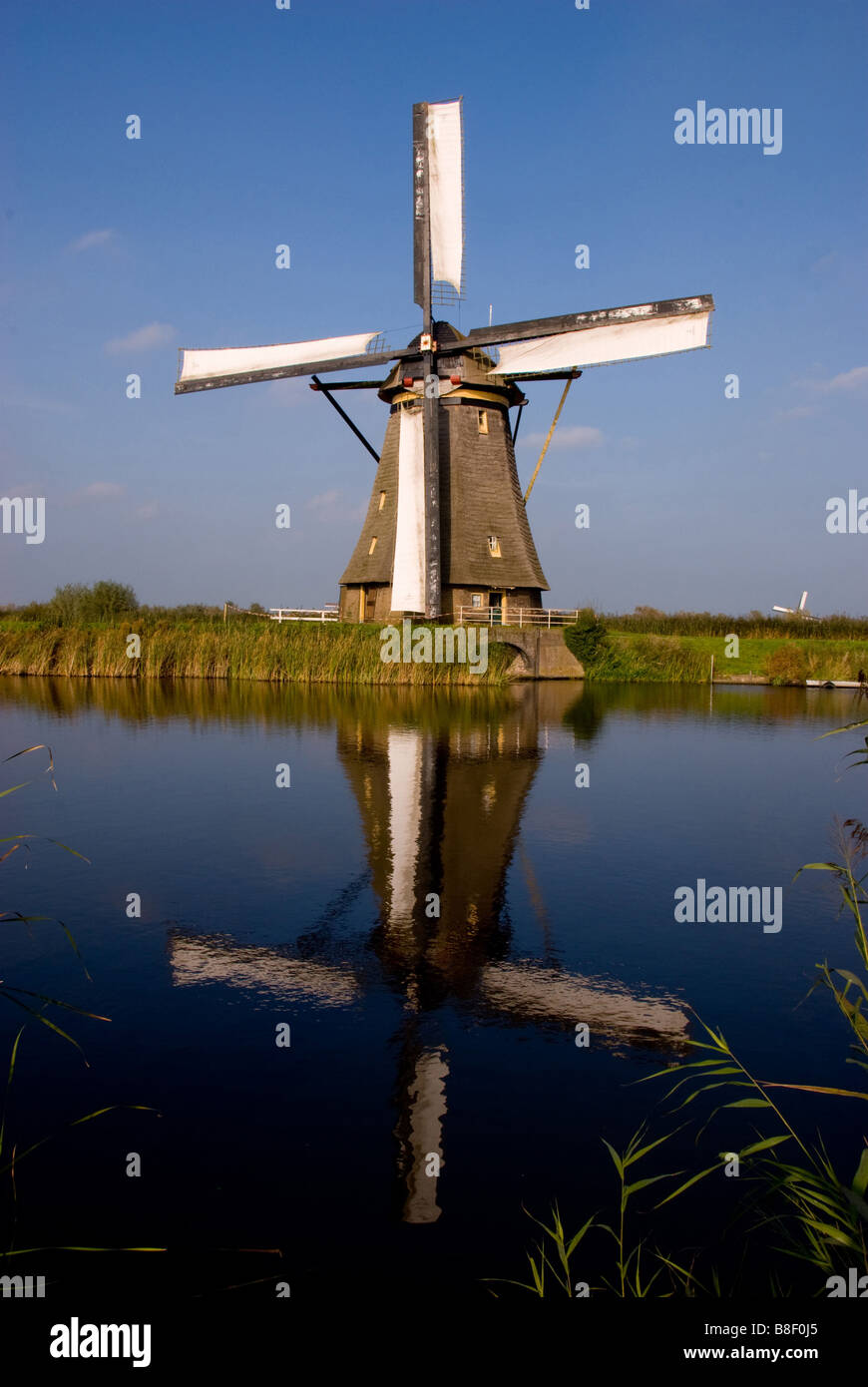 Traditional Dutch Windmill with reflection in blue river water Stock ...
