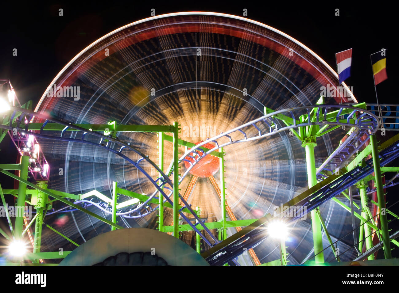 ferris wheel and a roller coaster at a carnival Stock Photo - Alamy