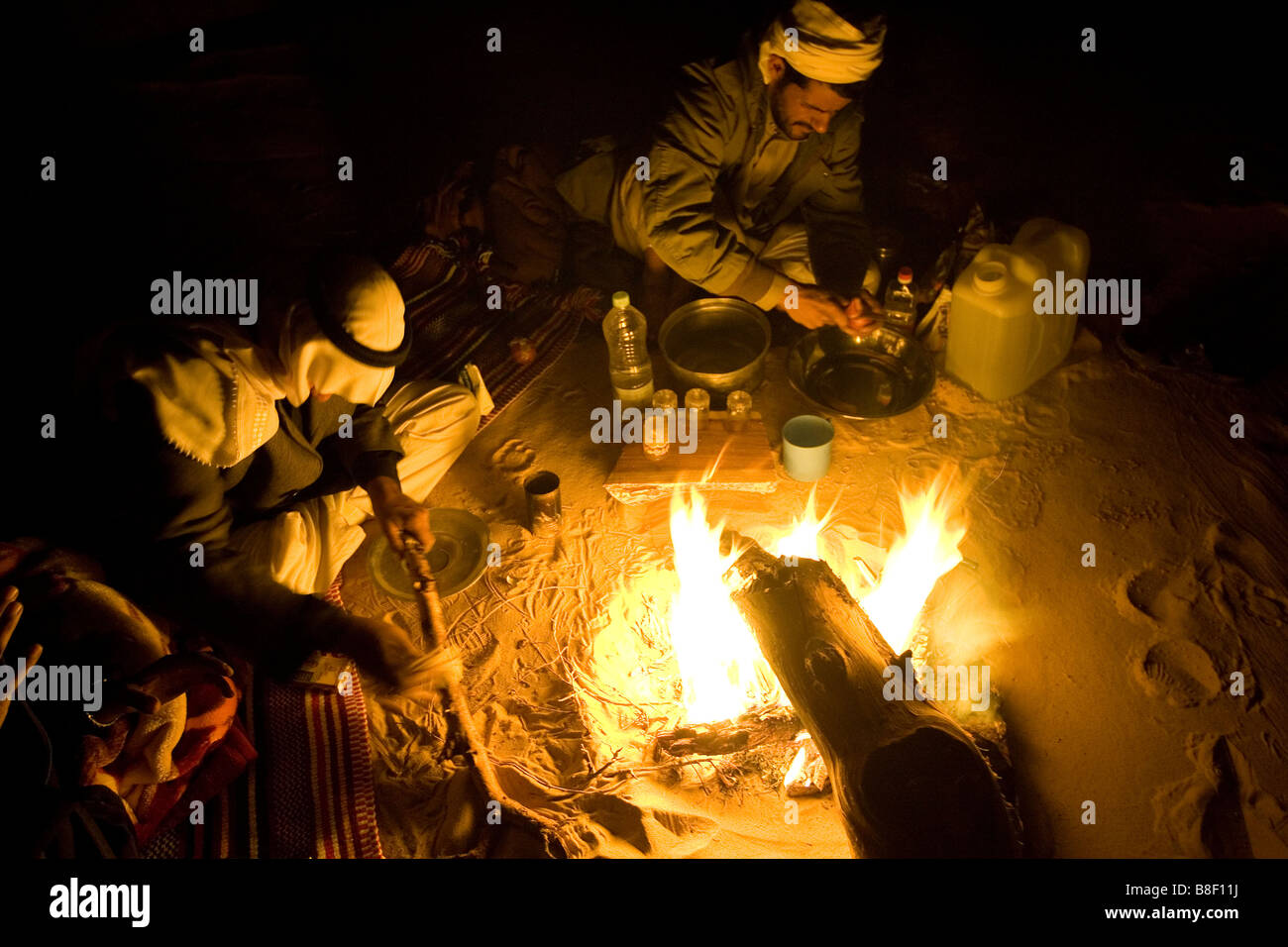 Three bedouin men around a camp fire in Egypt Stock Photo - Alamy