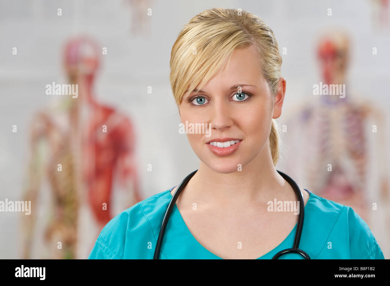 A beautiful female doctor in surgical scrubs shot in a hospital with ...