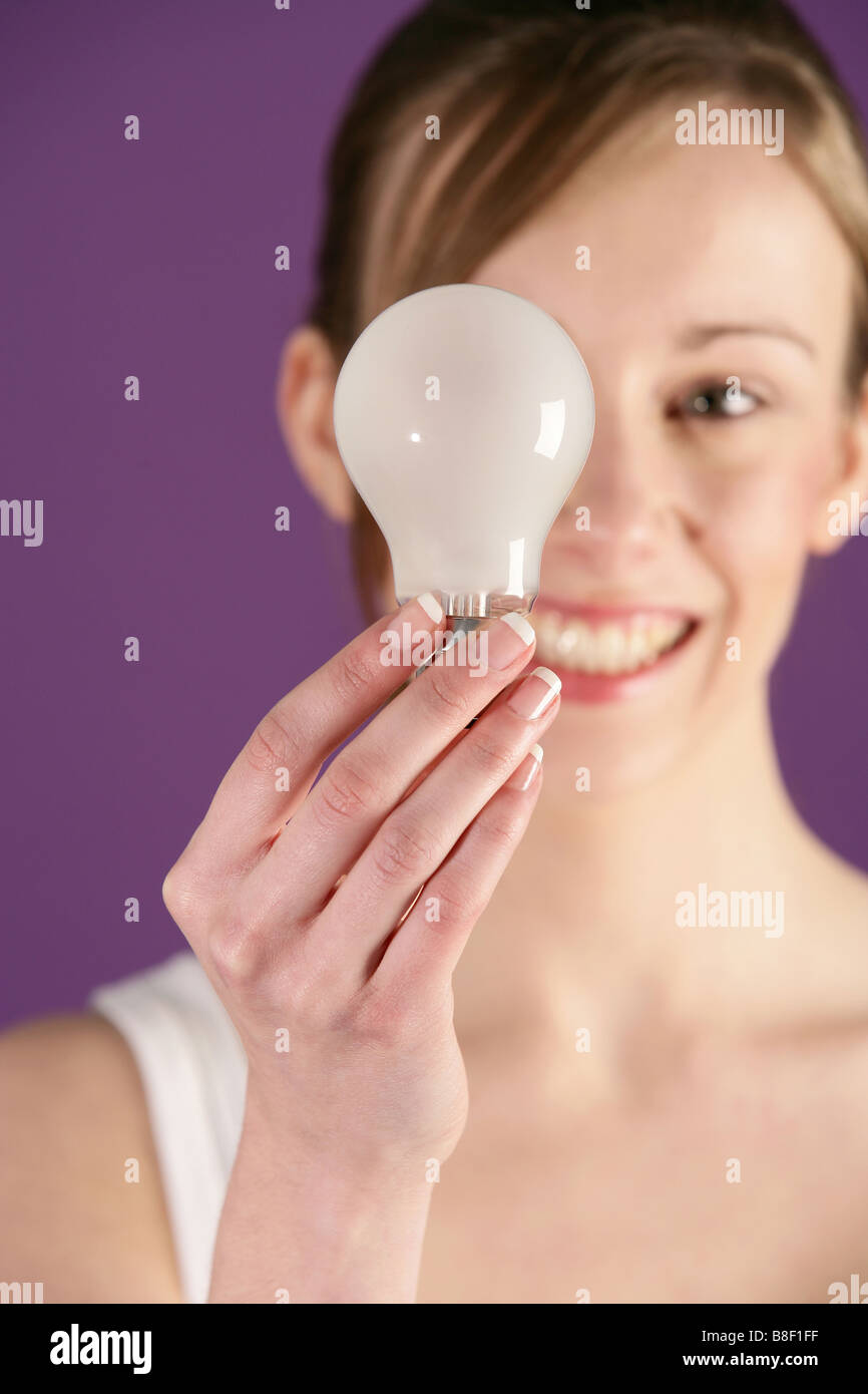 model holding traditional tungston light bulb Stock Photo - Alamy