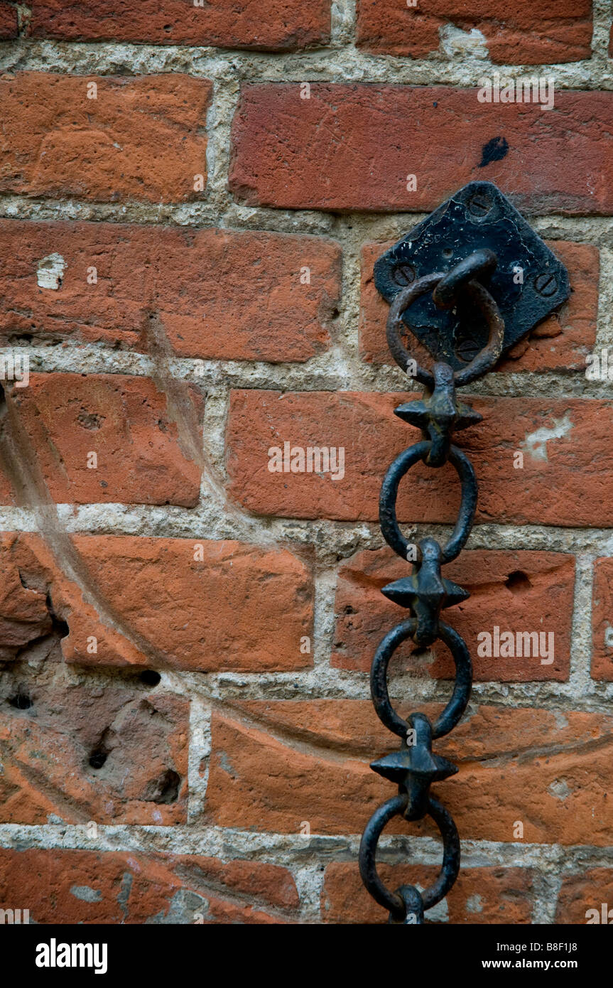 Chain wearing brick Stock Photo - Alamy