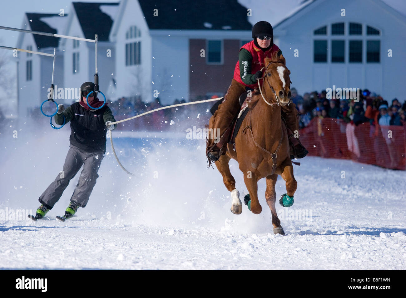 A rider on horseback pulls a skier in a winter event known as skijoring ...