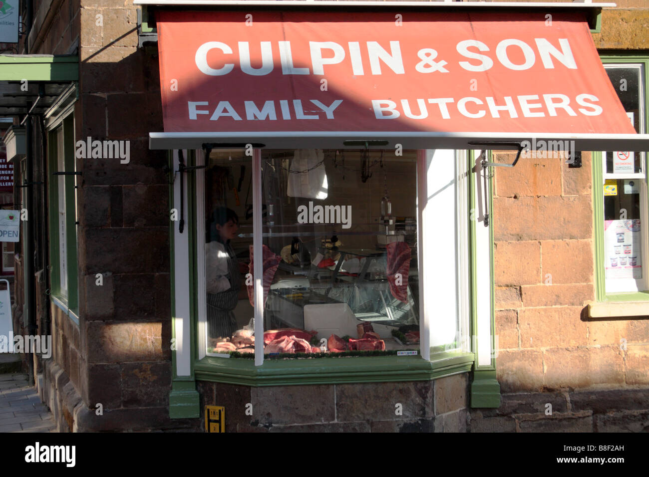 A traditional shop awning in front of a family butchers Stock Photo - Alamy
