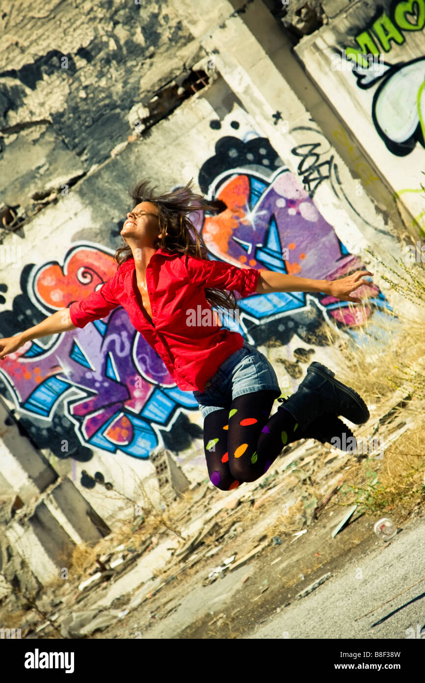 Young jumping woman in urban ruined background Stock Photo - Alamy