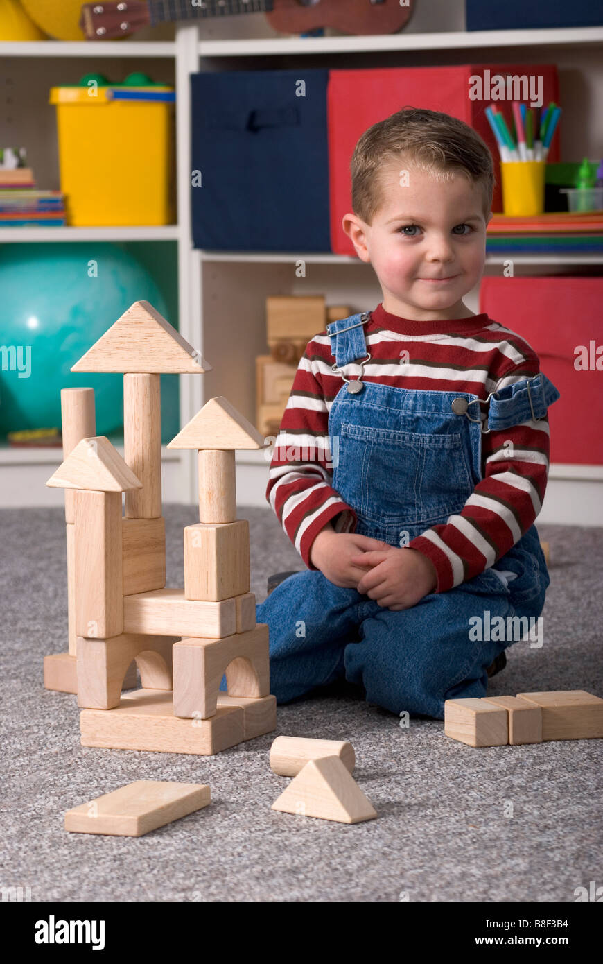Laughing Boy Building With Wooden Toy Blocks, Vertical Stock Photo - Alamy