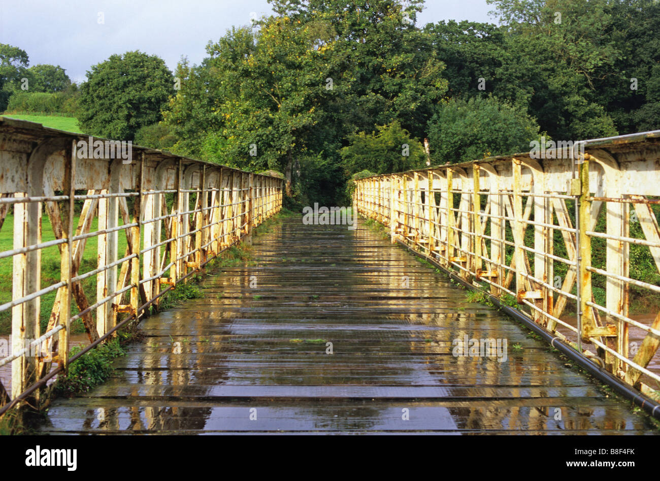 Footbridge over river Wye in the rain, Tintern, Wales, UK Stock Photo ...