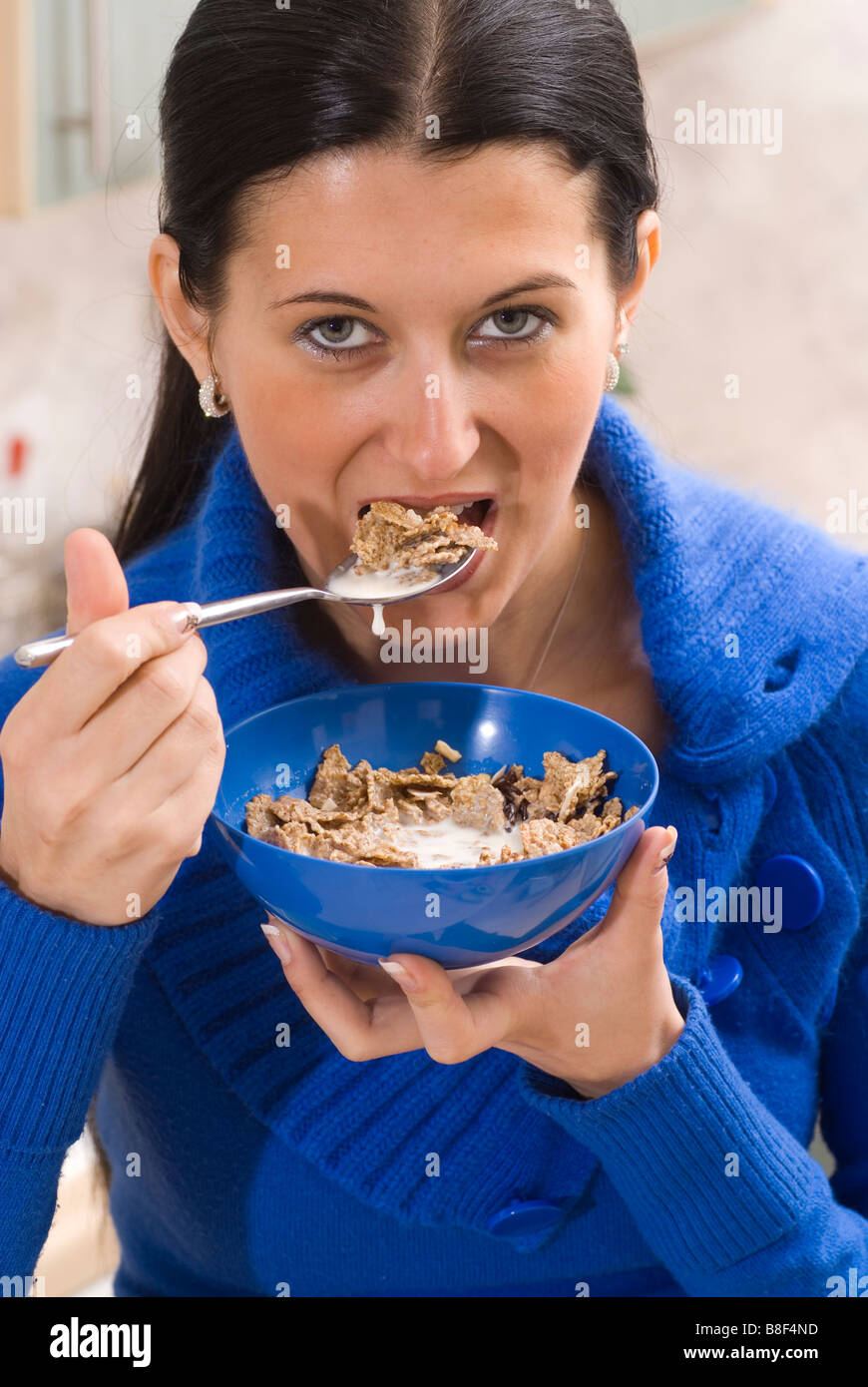 Young woman eating cereal breakfast Stock Photo - Alamy