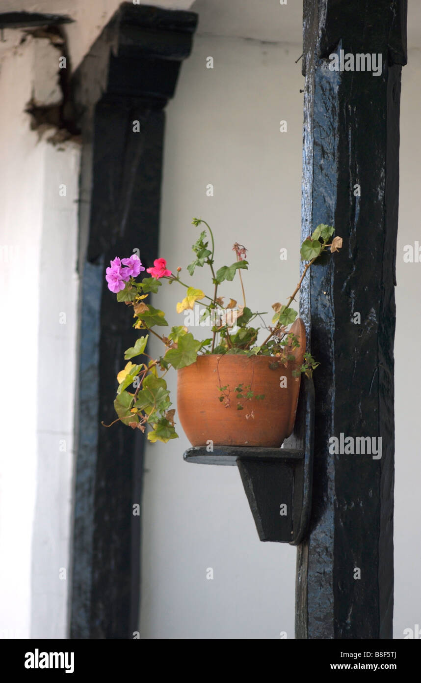 A flower pot hanging on the post of a home in Iza, Colombia Stock Photo ...