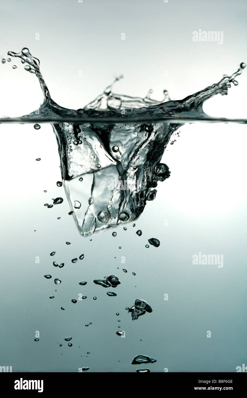An ice cube dropping into the water Stock Photo - Alamy