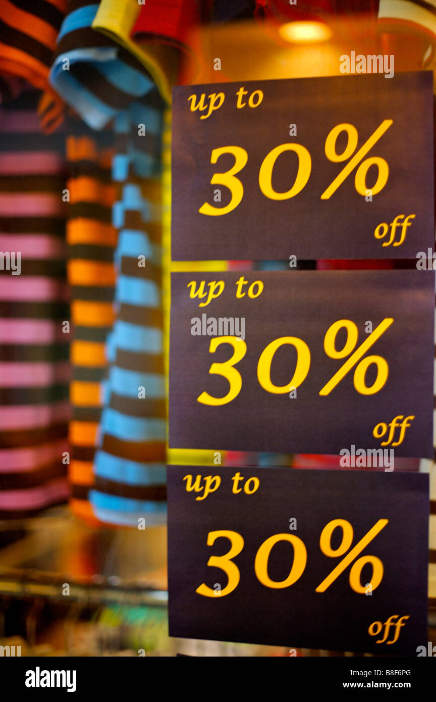 Discount signs on the window of a clothing store close up Stock Photo ...