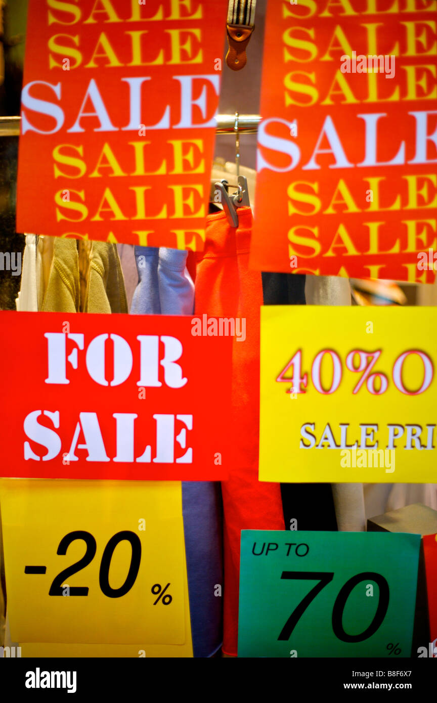 Colorful Sale and discount signs on the window of a clothing store in ...