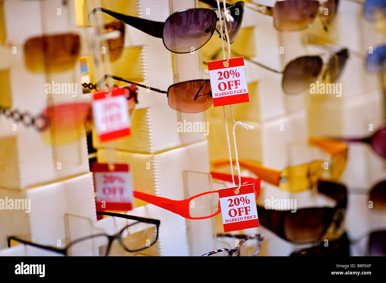 Discount signs hanging from sunglasses in a store Stock Photo - Alamy