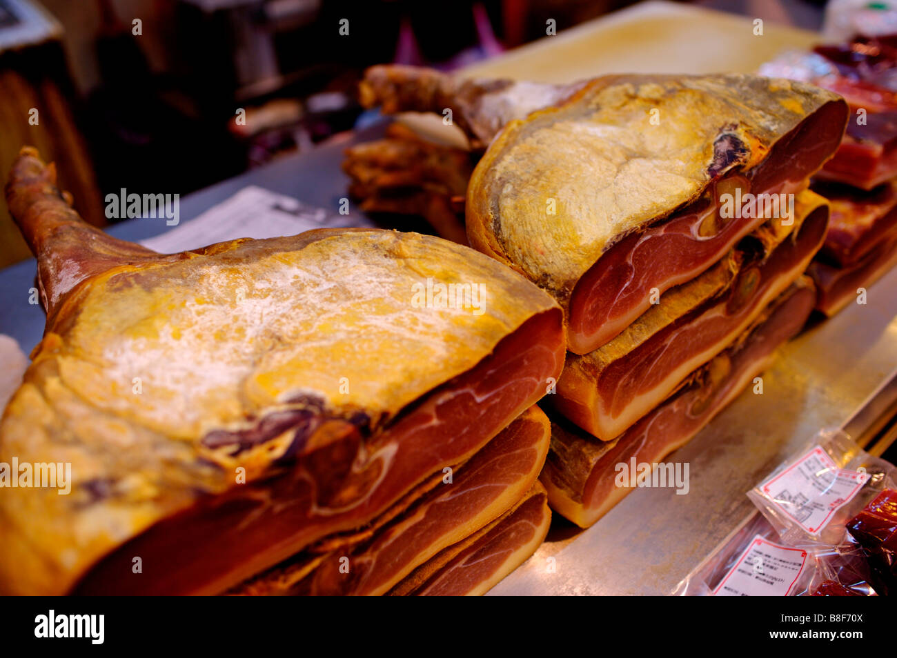 Cured pork in stacks on display in a market stall Stock Photo - Alamy