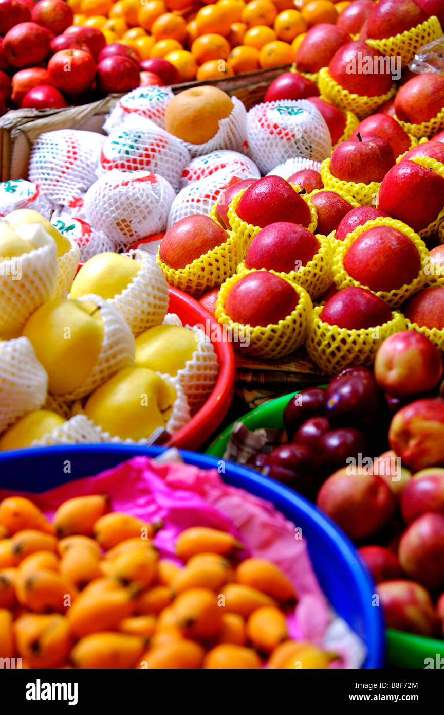 A variety of fresh fruit on display in plastic trays and boxes Stock ...