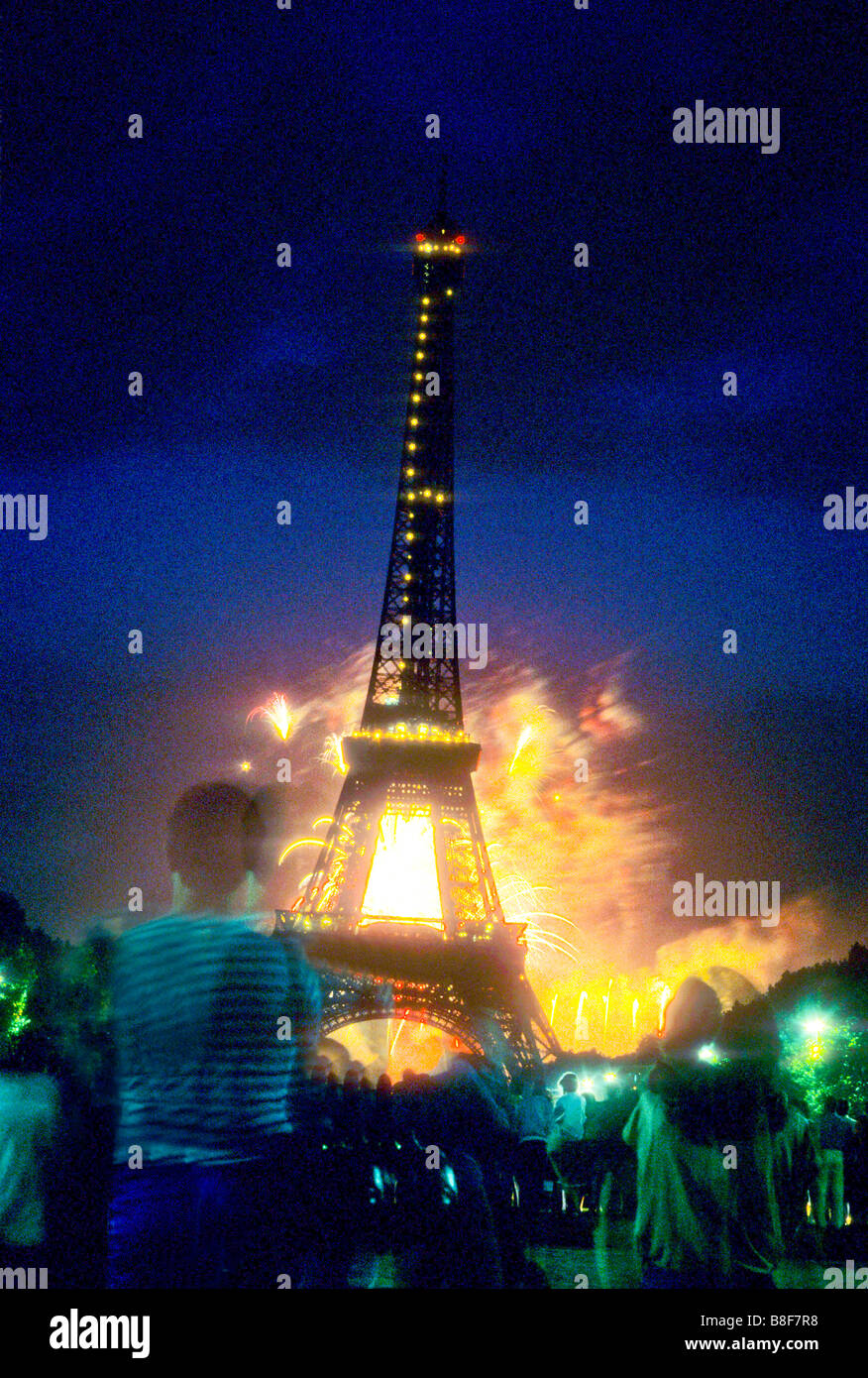 Fireworks light the sky behind the Eiffel Tower, Paris, on Bastille Day ...