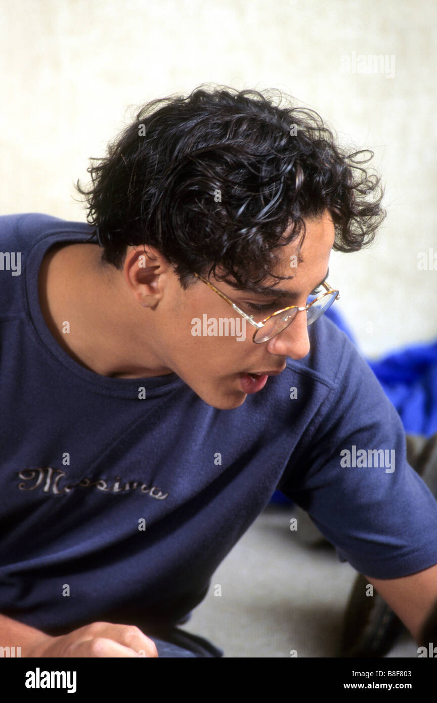 White teen boy looks intently at meter durng science class Stock Photo ...