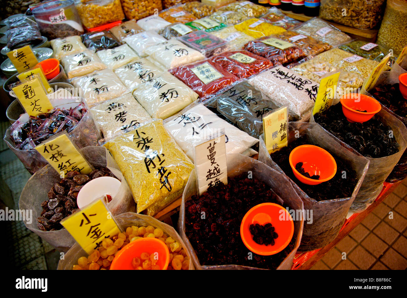 Dried goods in packs and in large plastic bags on display at a store ...