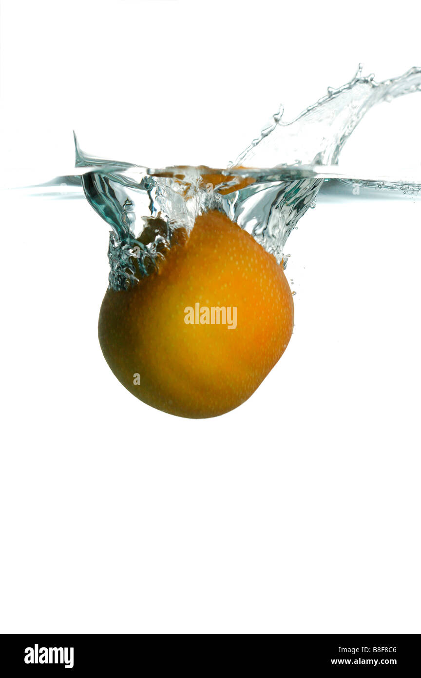 Pear falling into water splashing water upwards Stock Photo - Alamy