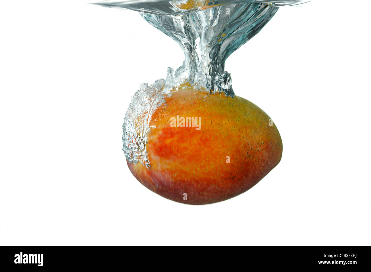 Ripe mango falling into water Stock Photo - Alamy