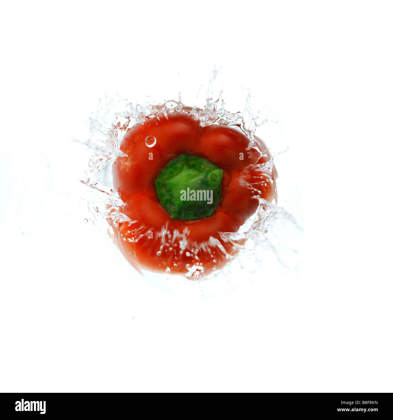 Red bell pepper falling into water high angle view Stock Photo - Alamy