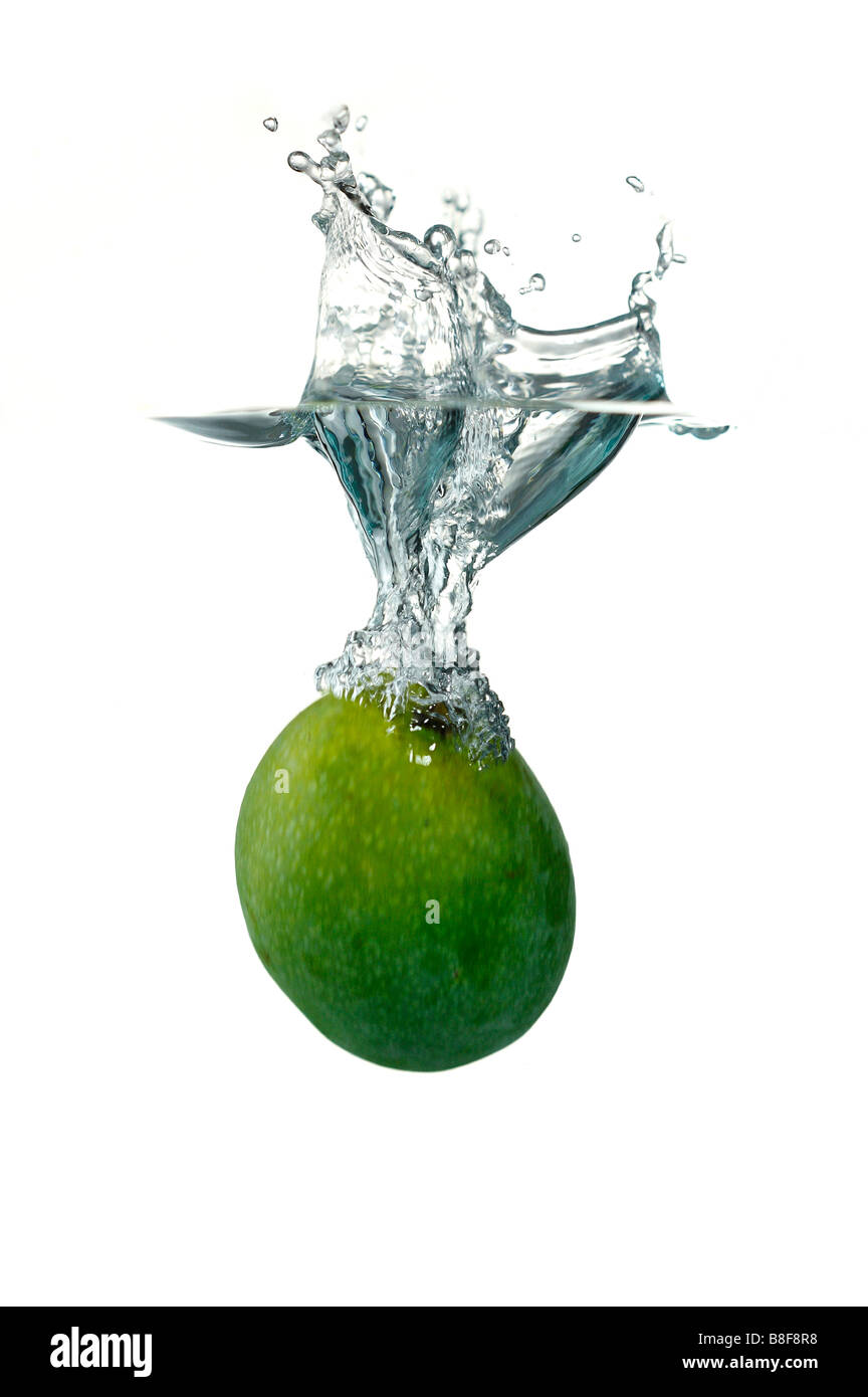 Unripe mango falling into water water splashing upwards Stock Photo - Alamy