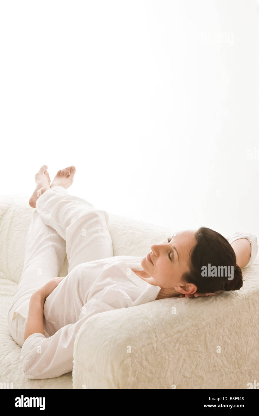 woman having nap on sofa Stock Photo - Alamy