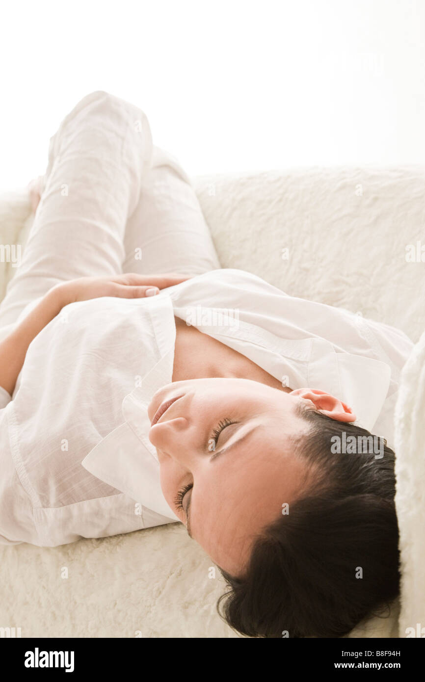 woman having nap on sofa Stock Photo - Alamy