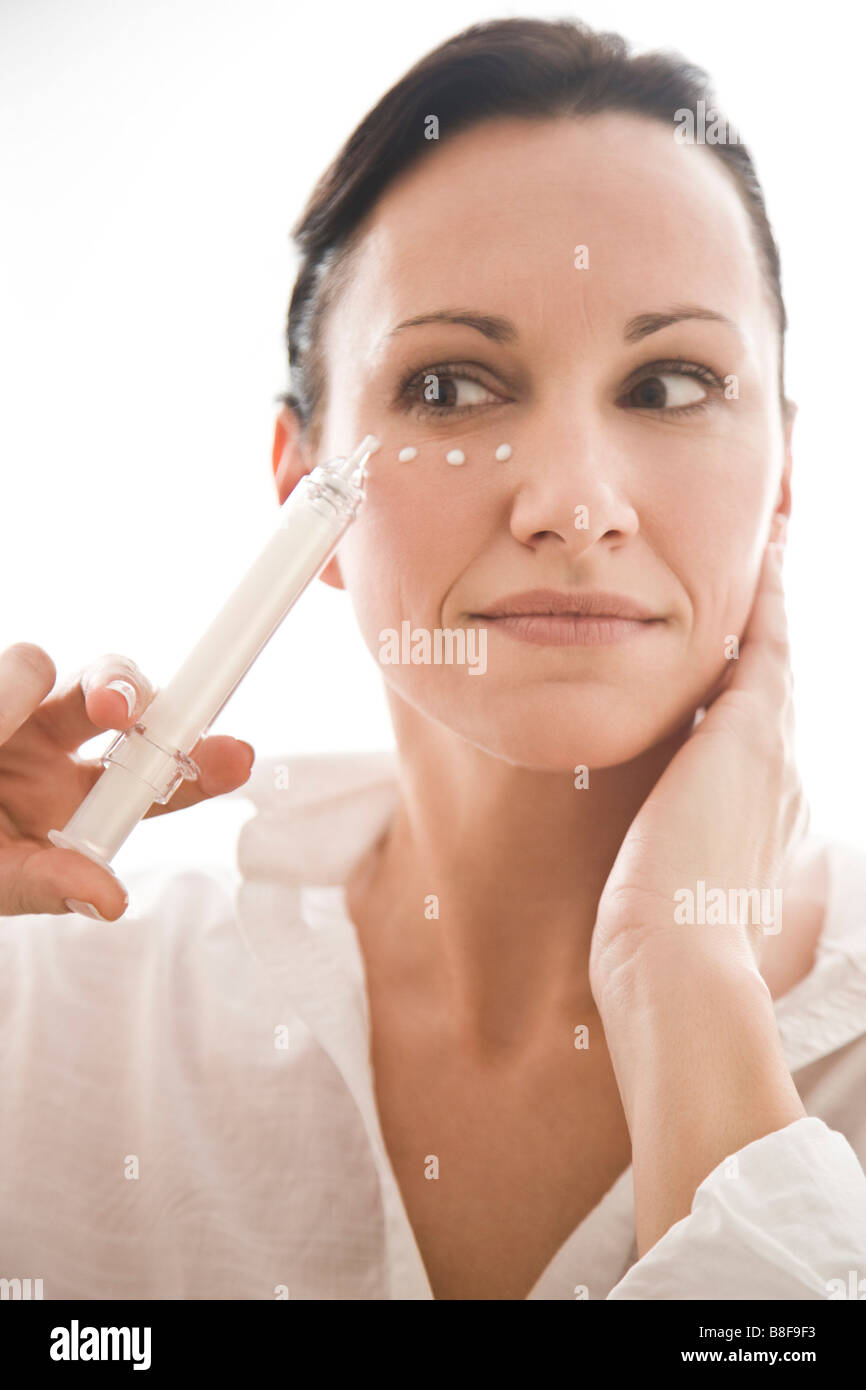 woman applying eye cream Stock Photo - Alamy