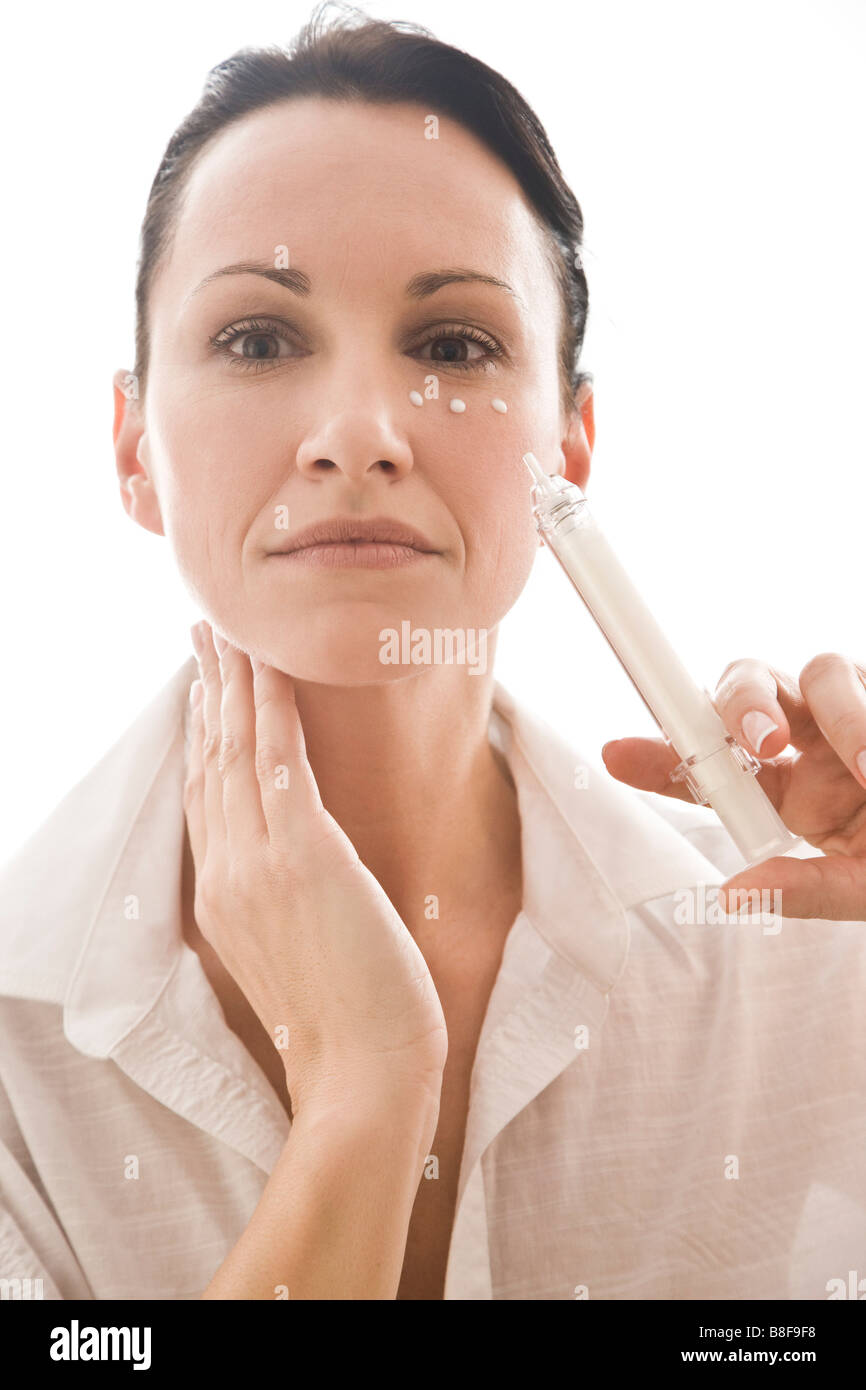 woman applying eye cream Stock Photo - Alamy