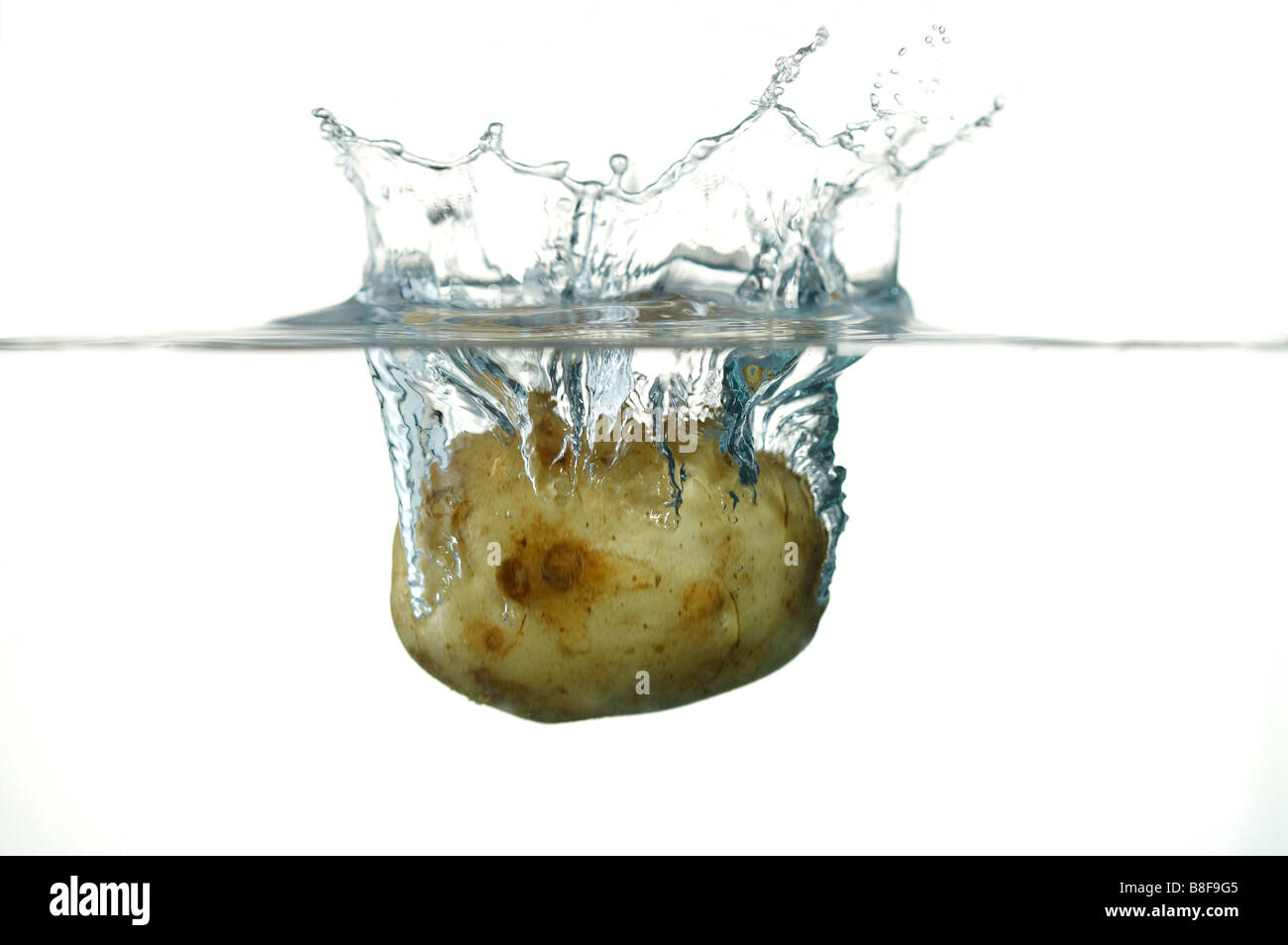 Potato falling into water Stock Photo - Alamy