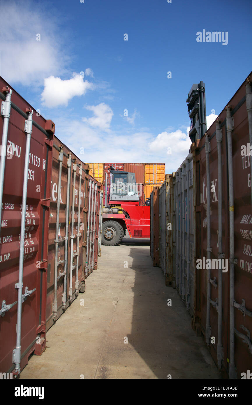 Corridor between shipping containers Stock Photo - Alamy