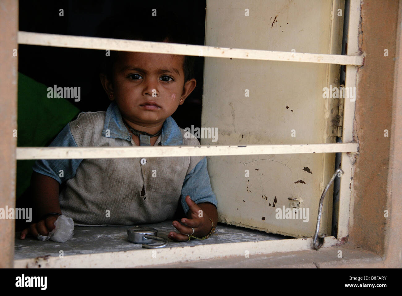 Indian boy looks from a school window Stock Photo - Alamy
