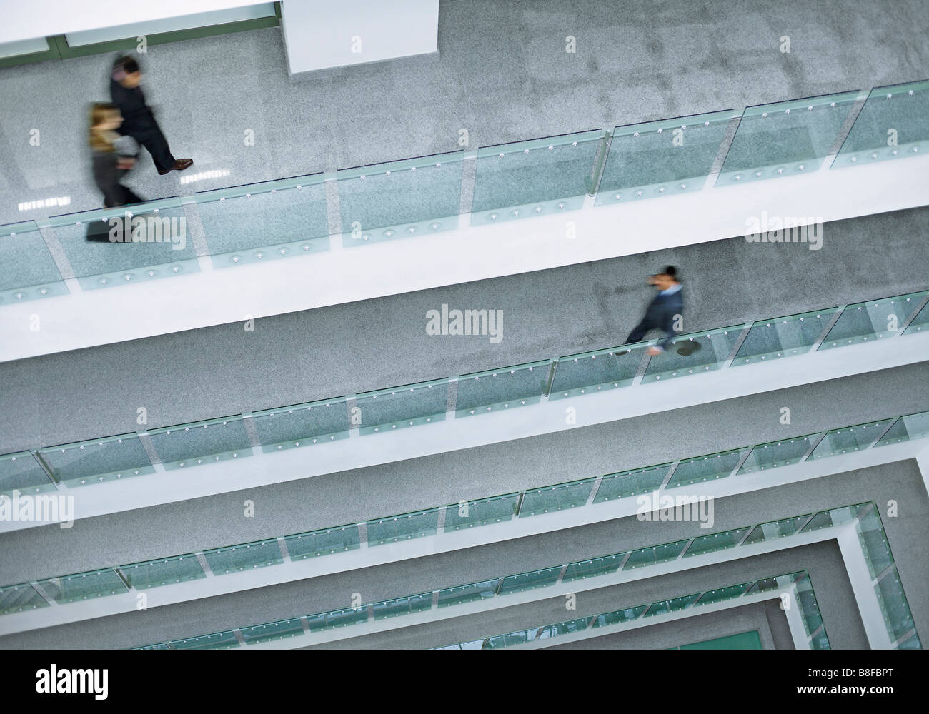 People walking along corridor in an office building Stock Photo - Alamy