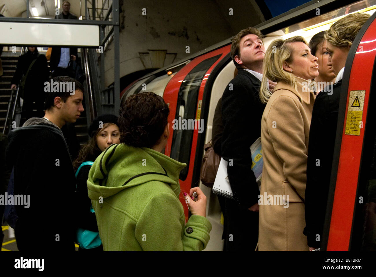 Commuters waiting to enter a London Underground tube during the rush ...