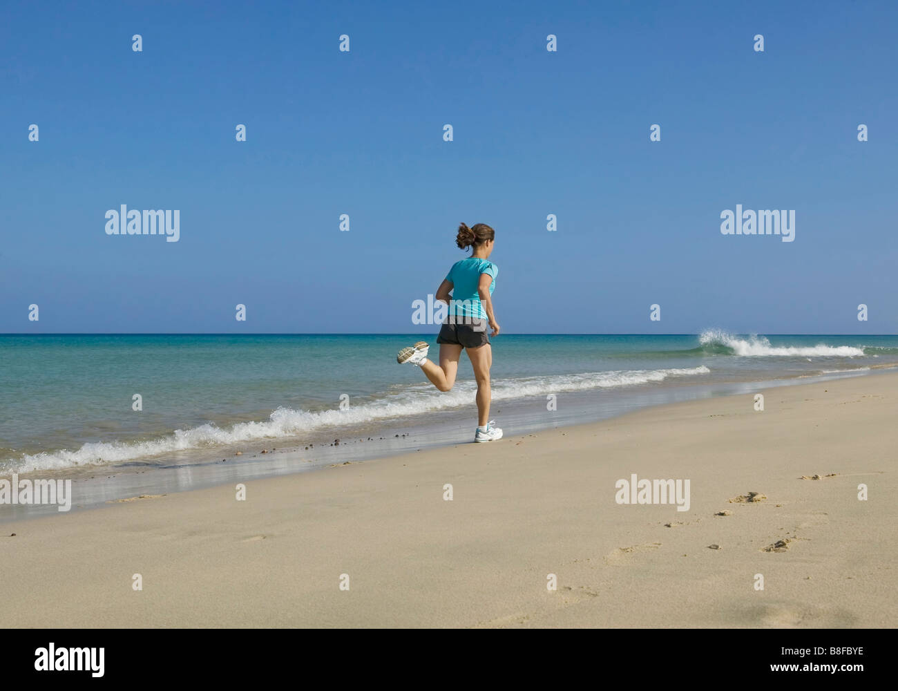 Young woman jogging at beach Stock Photo - Alamy