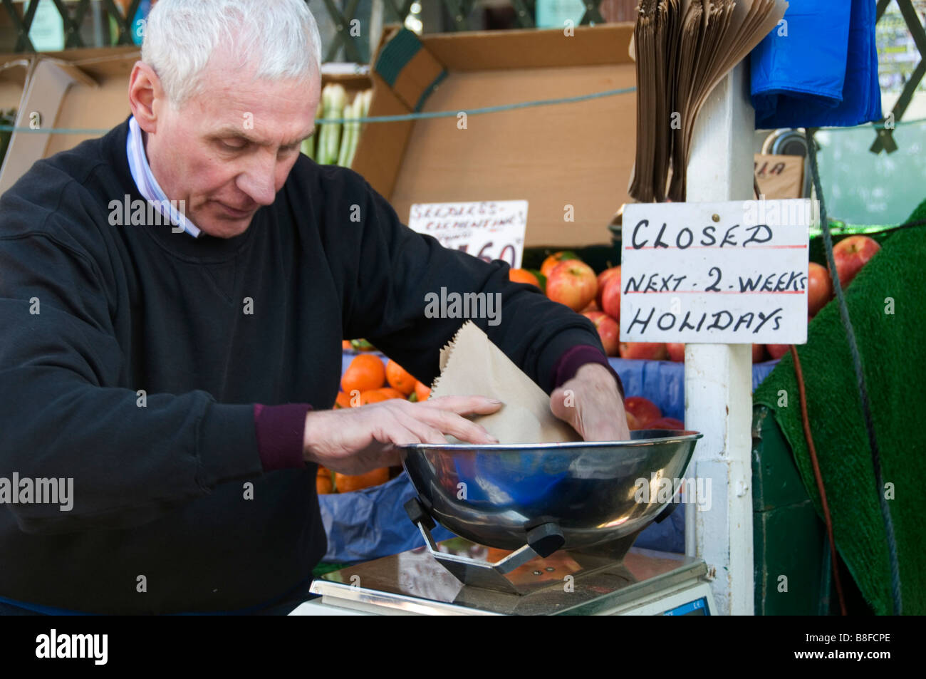 Hackney East London Broadway market Fruit and vegetable stall with sign ...