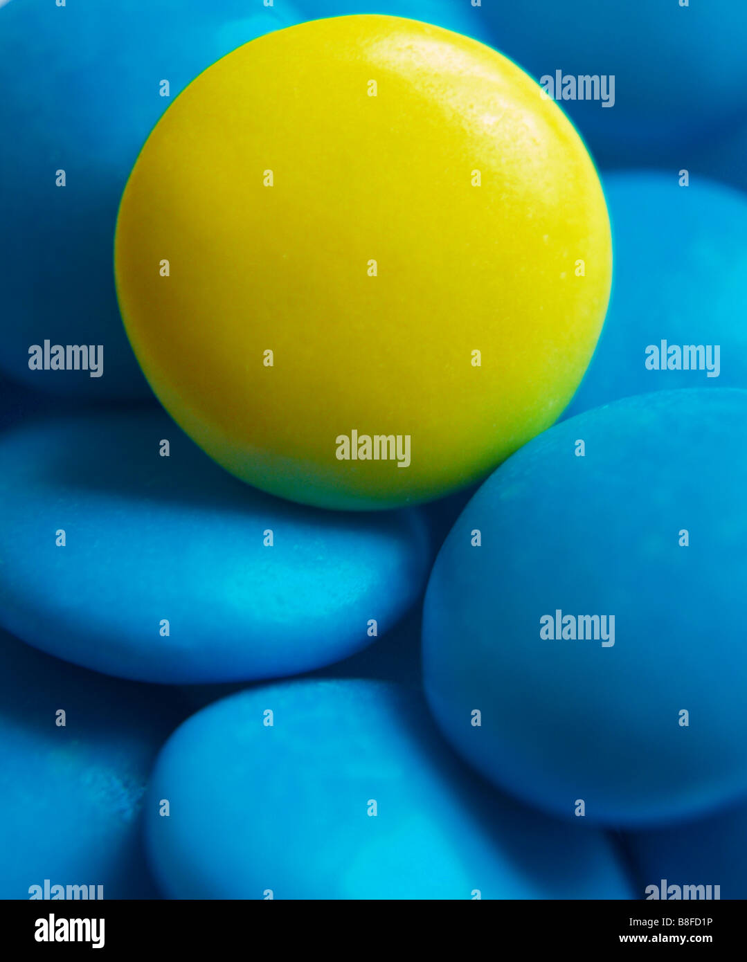 Close up of blue and yellow smarties Stock Photo - Alamy