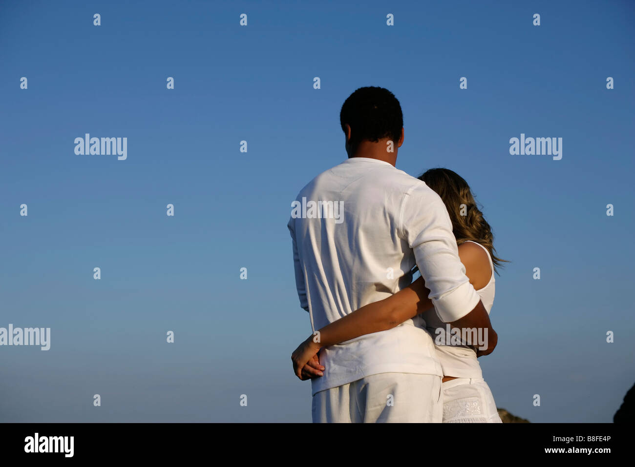 Couple embracing one another Stock Photo - Alamy