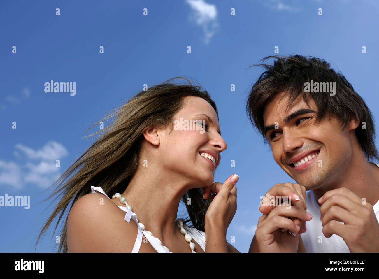 Couple holding hands and smiling each other Stock Photo - Alamy