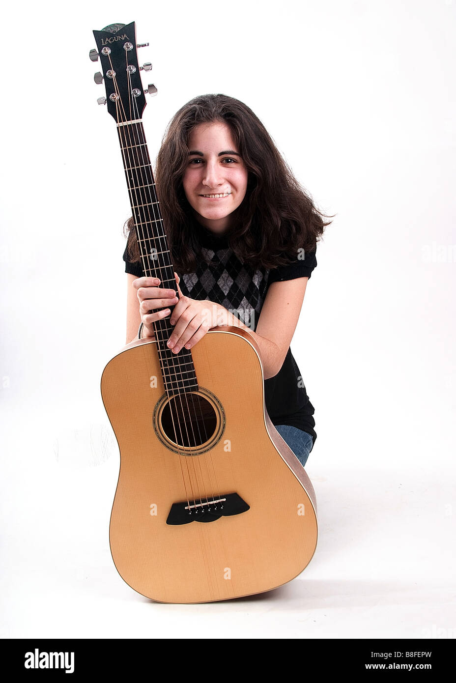 a young teenage girl holding an acoustic guitar Stock Photo - Alamy